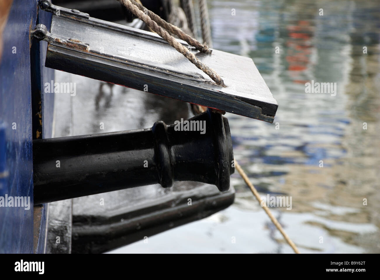 Cannon muzzle points through a gunport onboard the Earl of Pembroke ...