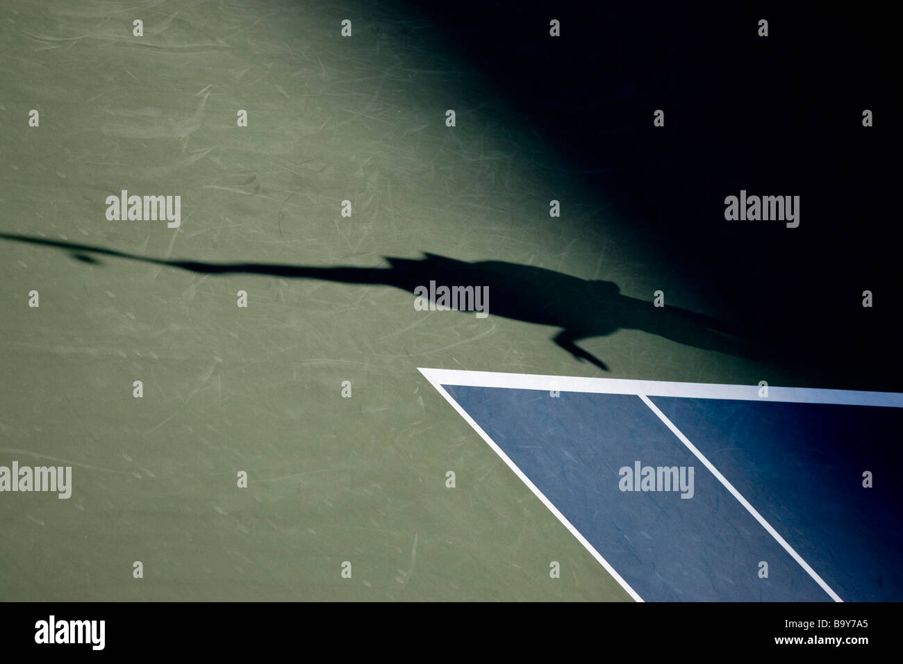 Shadow of tennis player serving Stock Photo - Alamy