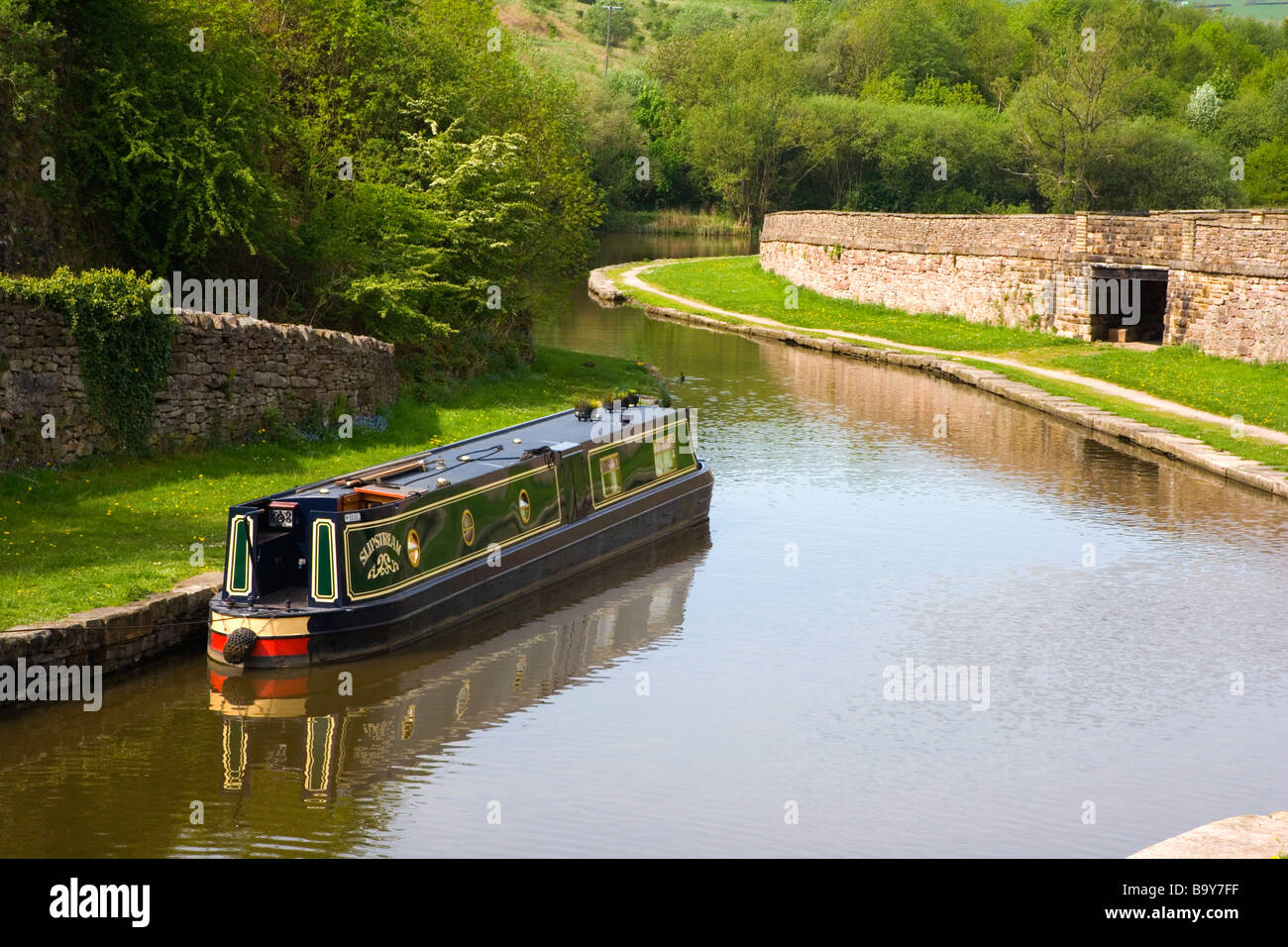 A Narrow Boat moored on the Peak Forest Canal at Bugsworth Basin in ...