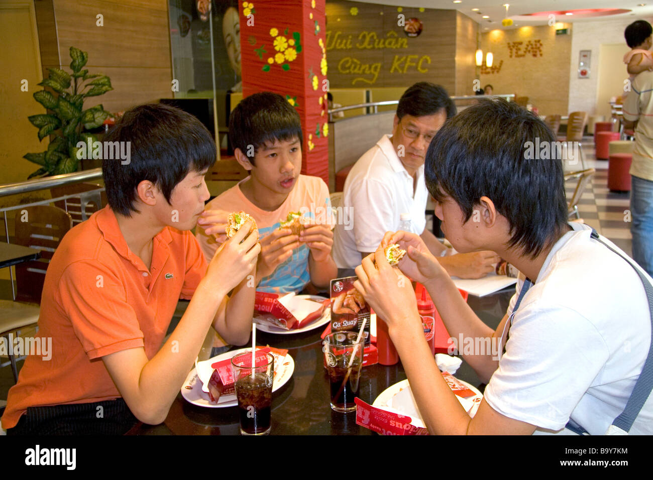 Vietnamese people eat at a KFC restaurant inside the Diamond Plaza ...