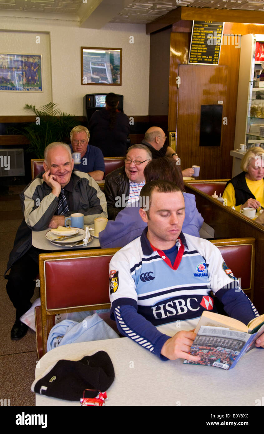 Customers eating drinking and chatting in Carpaninis Cardiff Arms Cafe ...