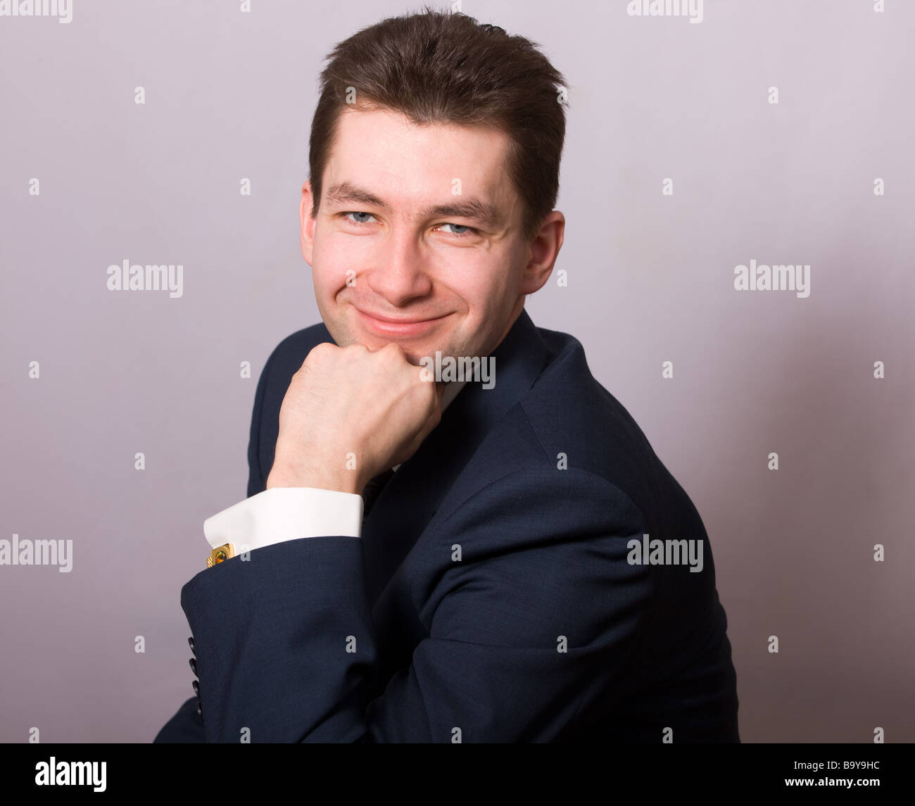 Sad smiling man portrait in a blue suit on white background Stock Photo ...