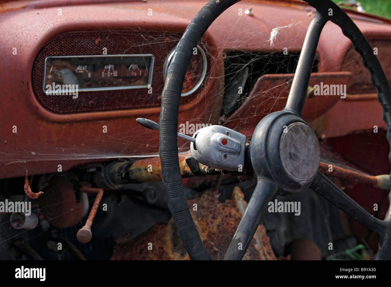 Abandoned a rusty old red car accessories steering wheel in open in ...
