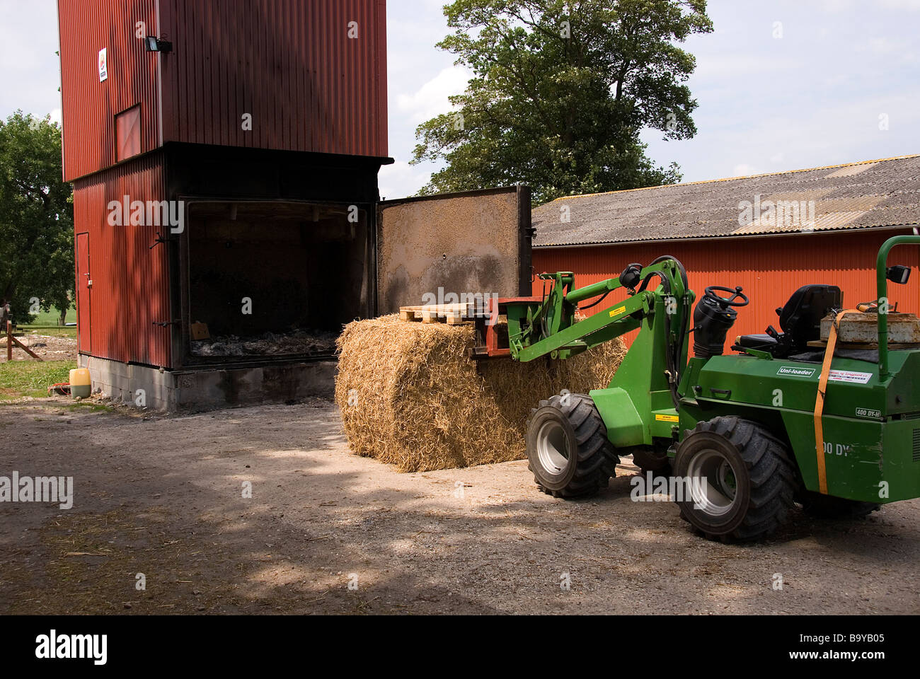 Famer about to fuel his straw furnace with a big bale Jutland Denmark ...
