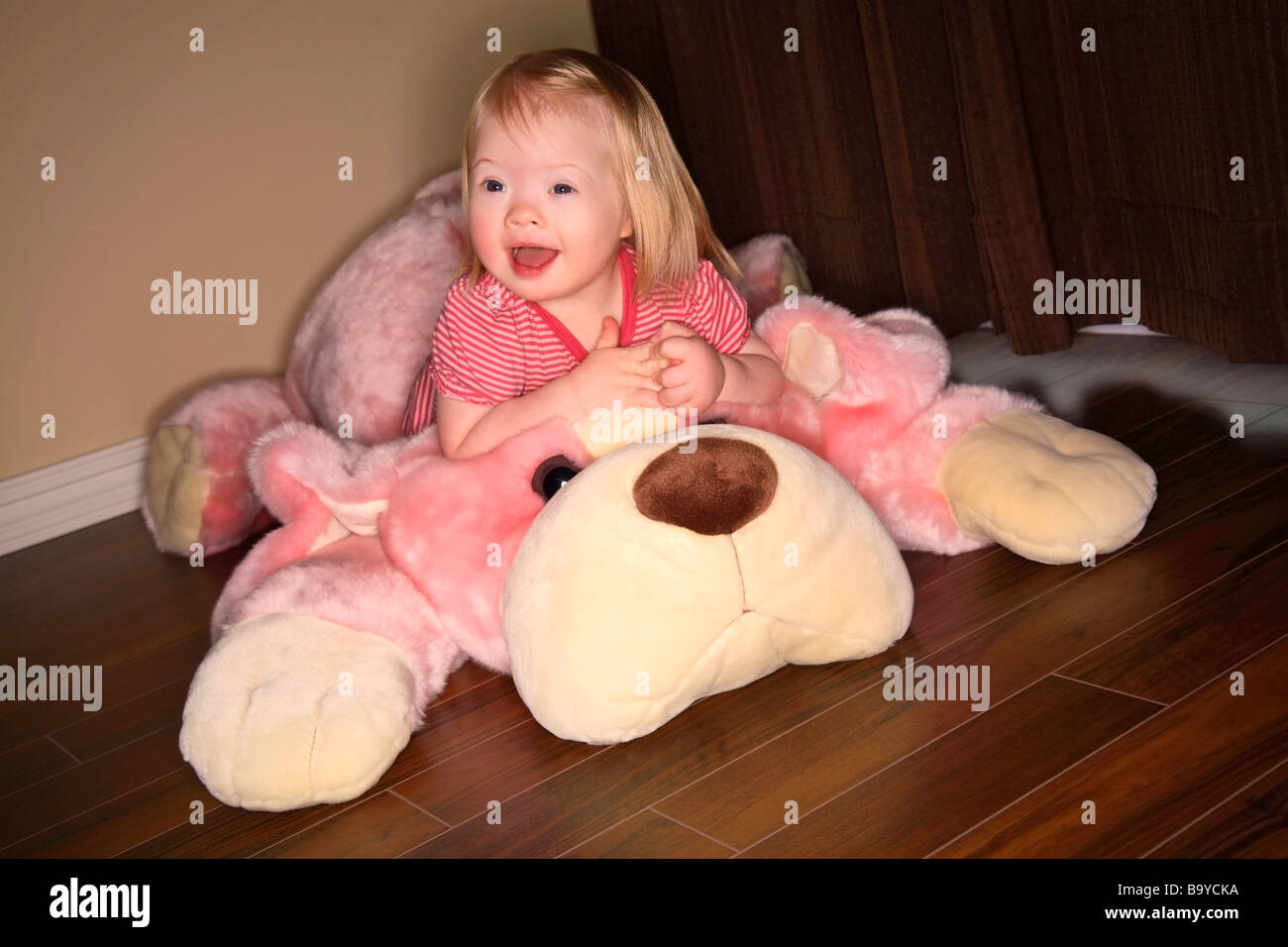 Girl sitting on stuffed animal Stock Photo - Alamy
