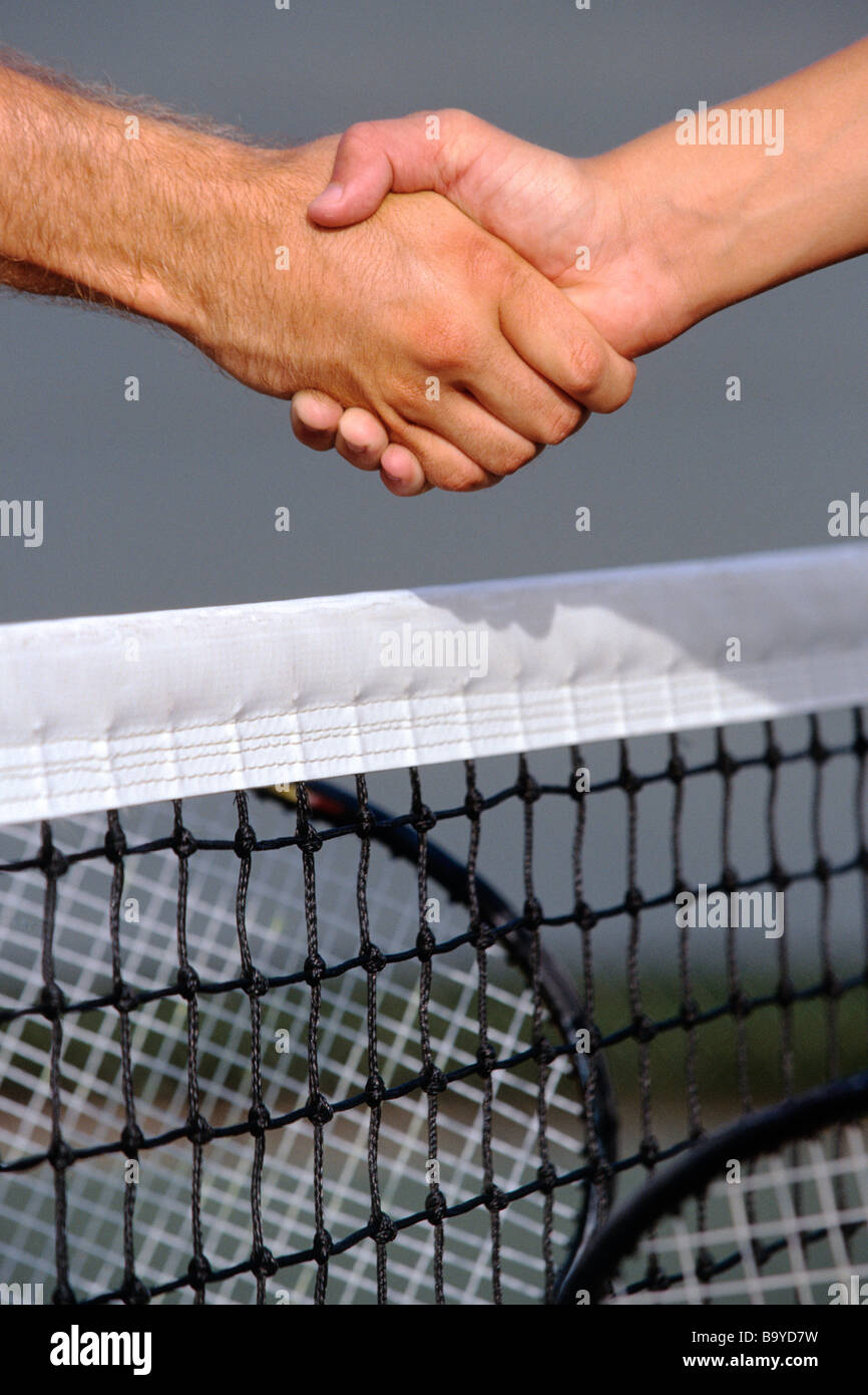 Tennis players handshake over the net Stock Photo - Alamy