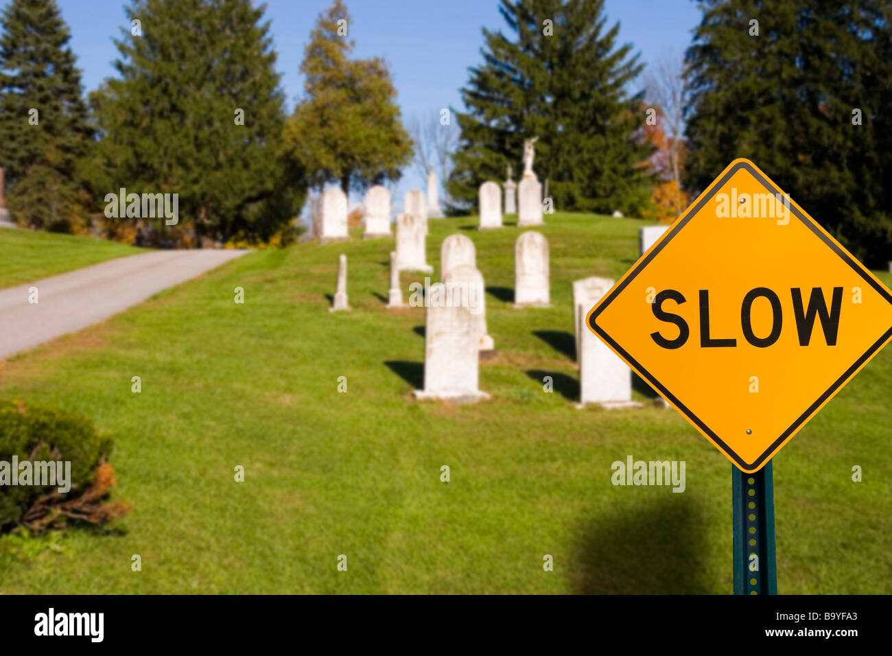 Slow road sign near cemetery what does it mean Stock Photo - Alamy