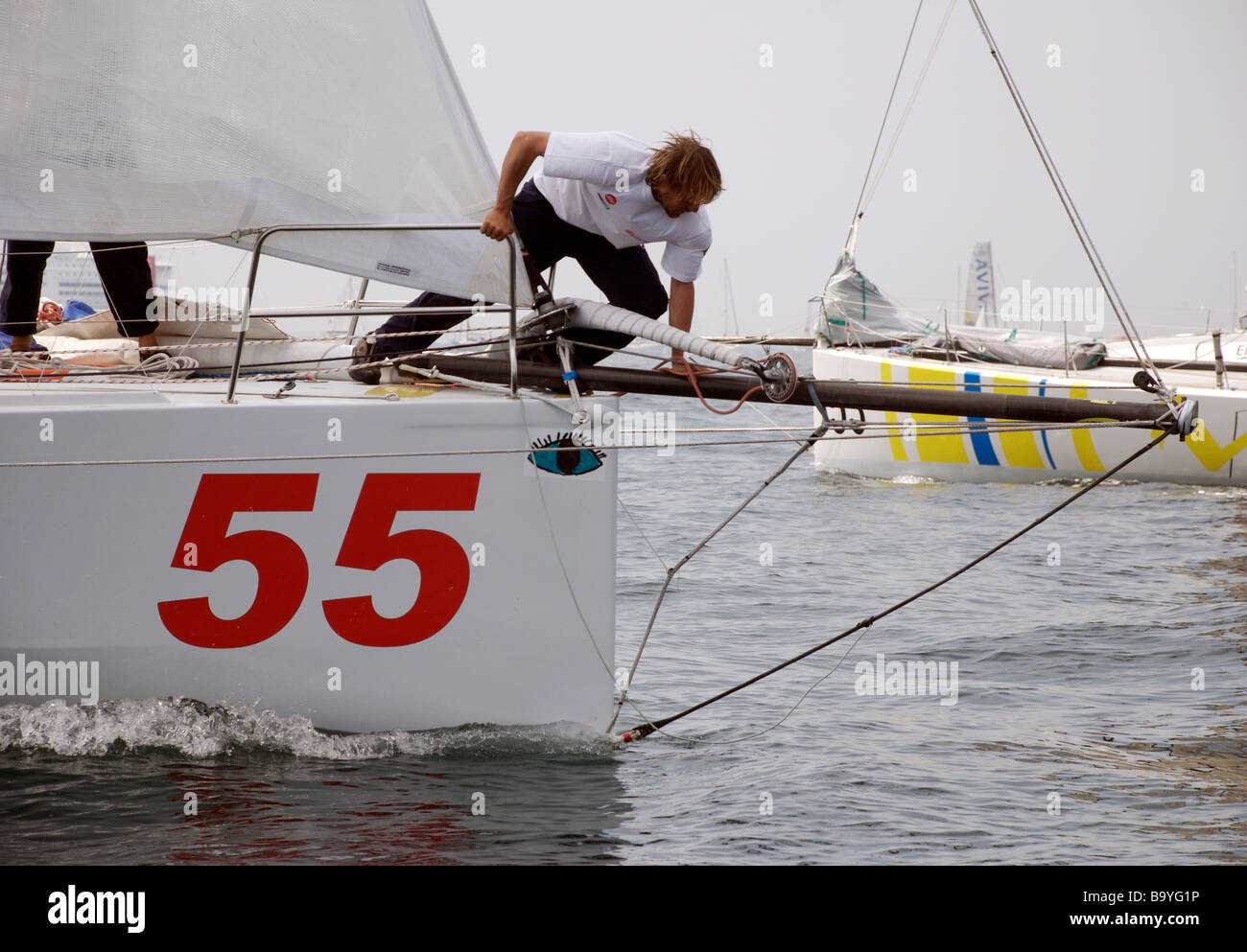 Team member at the bow of number 55 Telecom Italia yacht, Class 40 ...