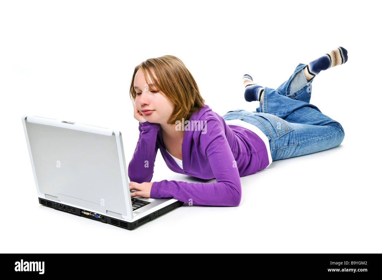 Young girl lying down with laptop computer Stock Photo - Alamy
