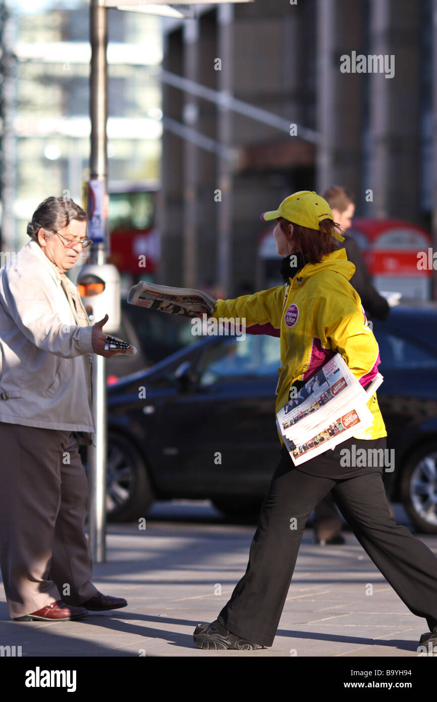 Handing out newspaper hi-res stock photography and images - Alamy