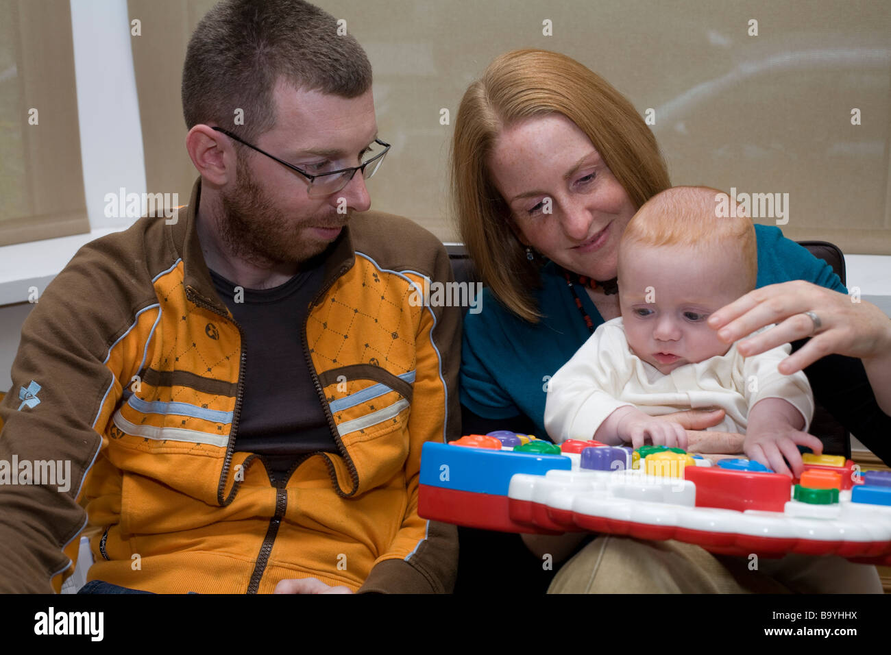 parents play with baby boy Stock Photo - Alamy