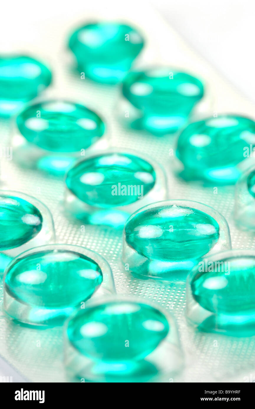 Headache Capsules isolated against a white background Stock Photo - Alamy