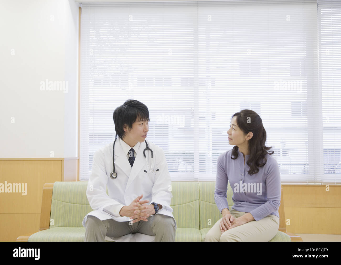 Doctor and patient talking Stock Photo - Alamy