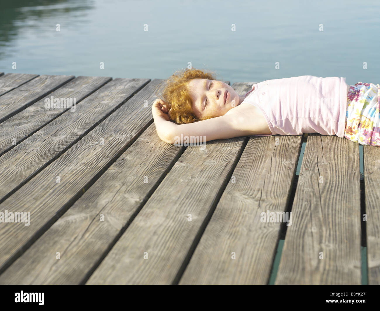 Girl lying on back sunbathing hi-res stock photography and images - Alamy