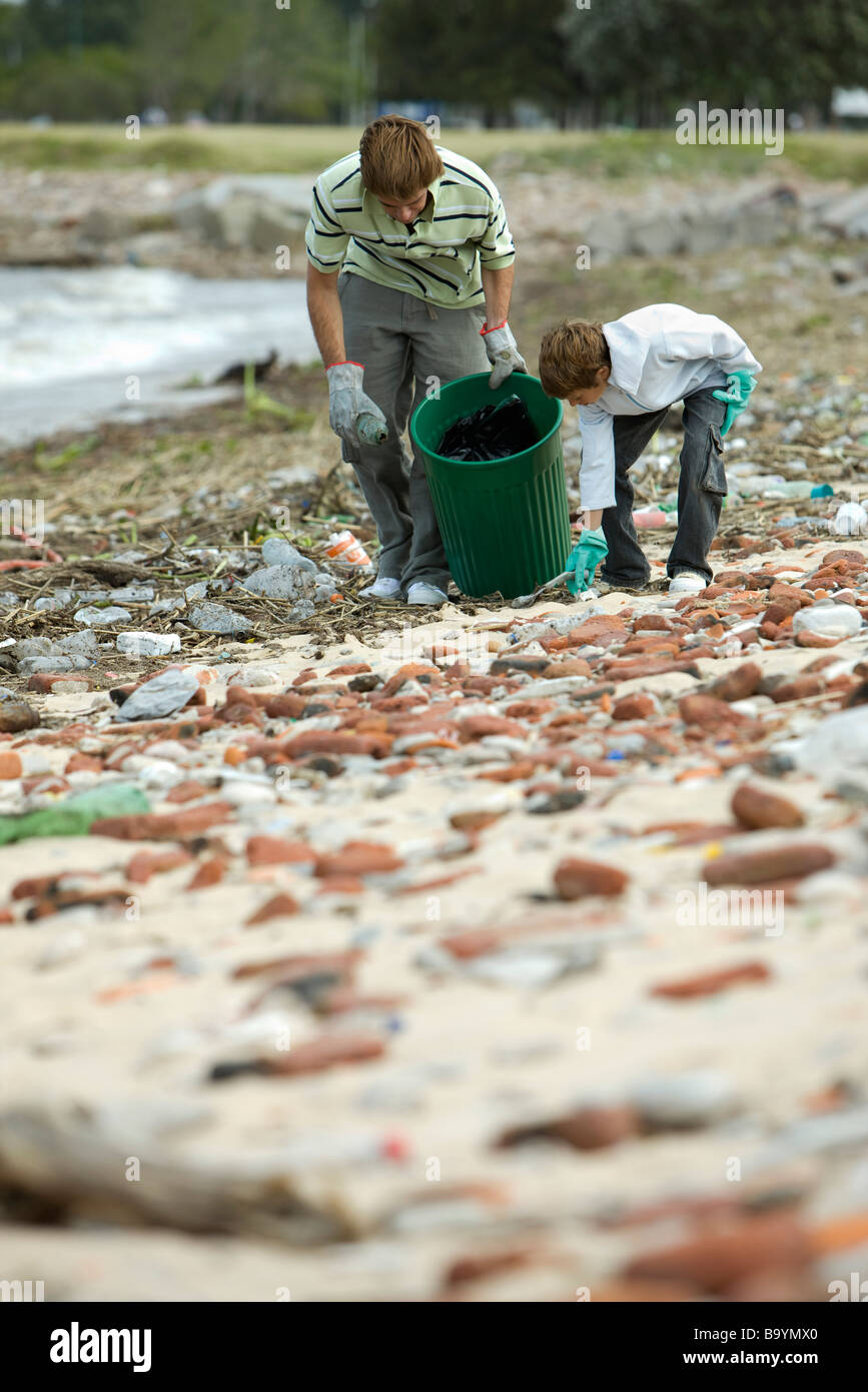 Two people collecting trash outdoors Stock Photo - Alamy
