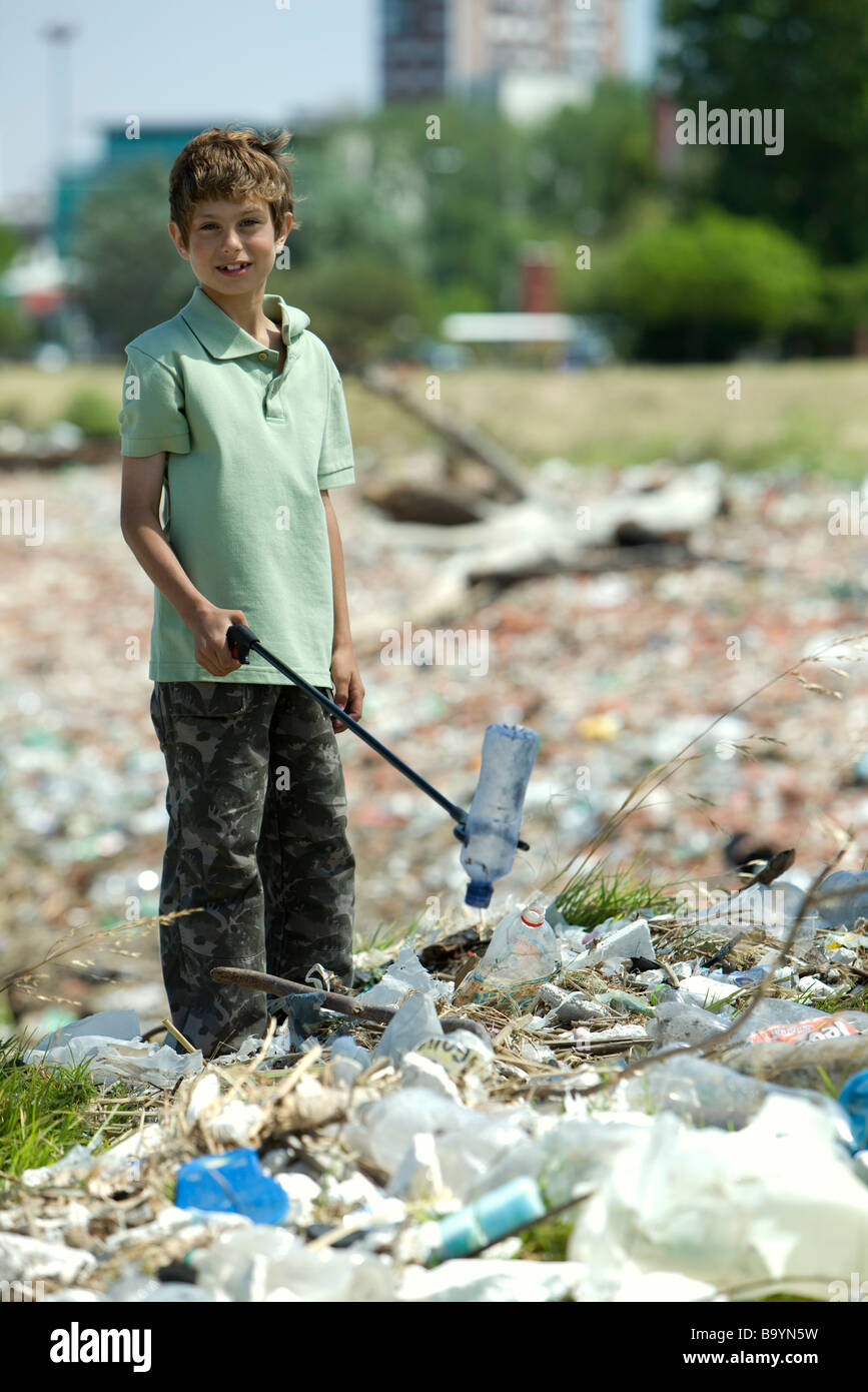 Boy standing in garbage dump hi-res stock photography and images - Alamy