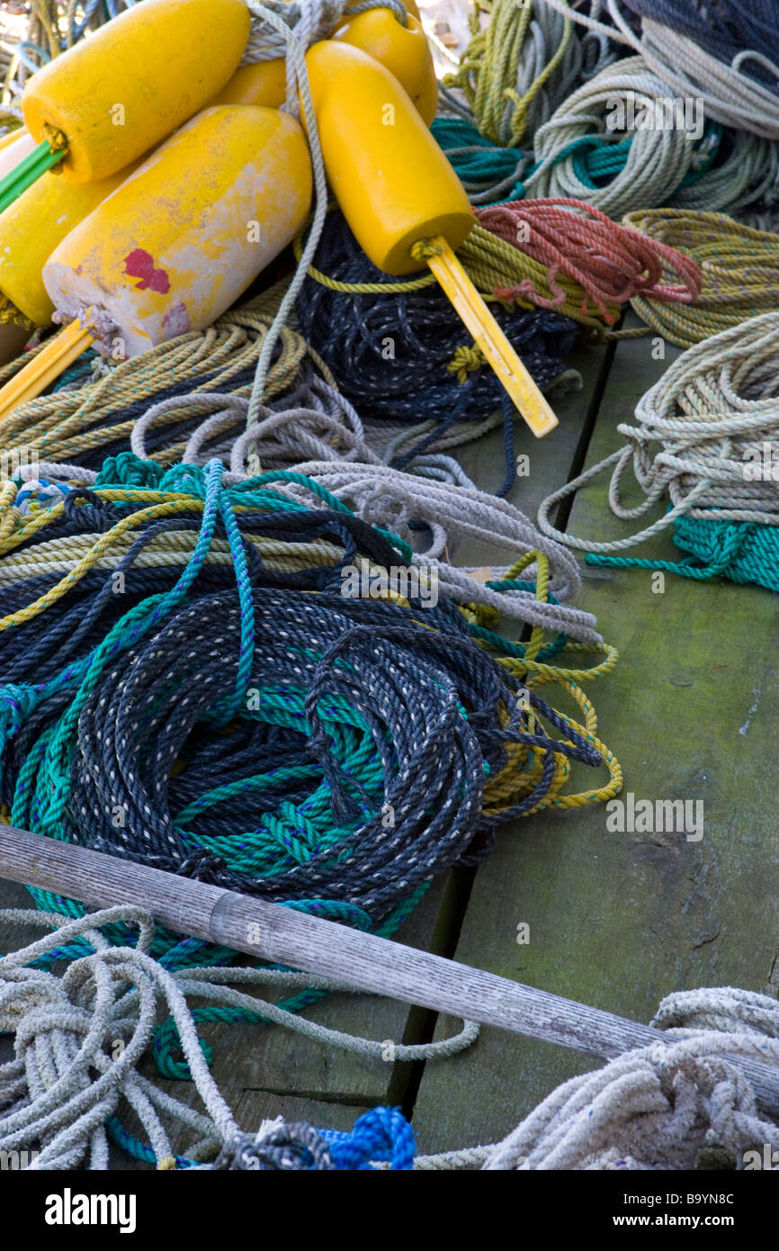 Lobster traps buoys and rope coils on a dock in coastal Maine Stock ...