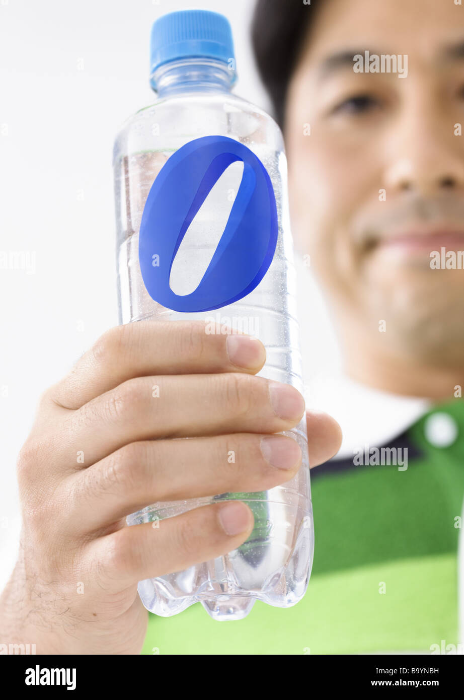 A man holding a plastic bottle Stock Photo - Alamy