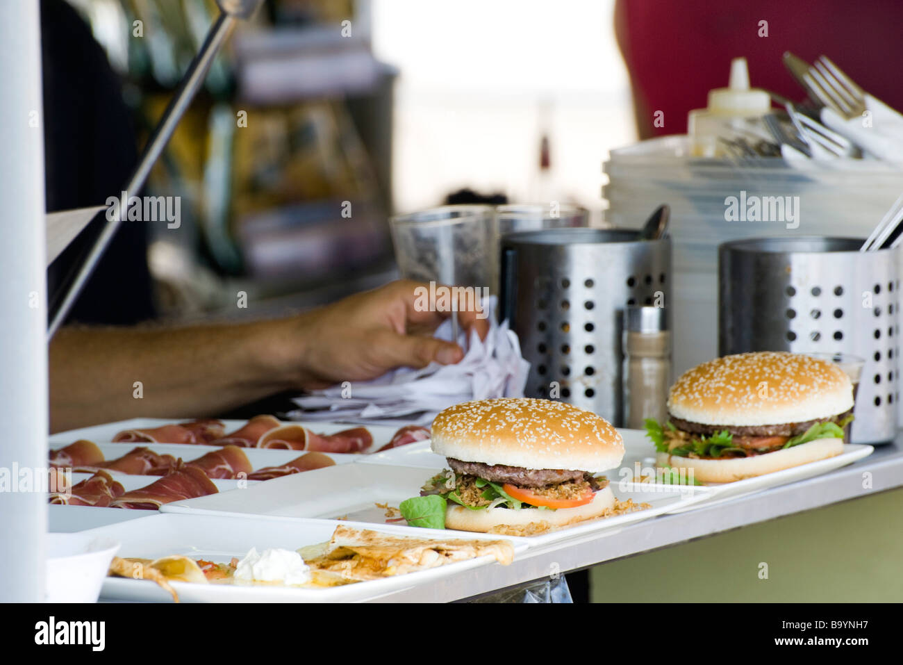 Hamburgers freshly prepared by cook waiting to be served to customers ...