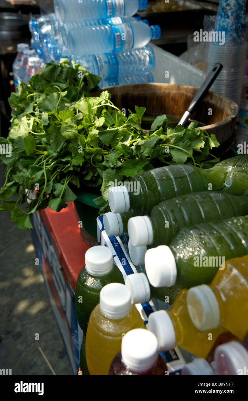 Close up of green leaf cooling drink mixture and bottles Bangkok street ...