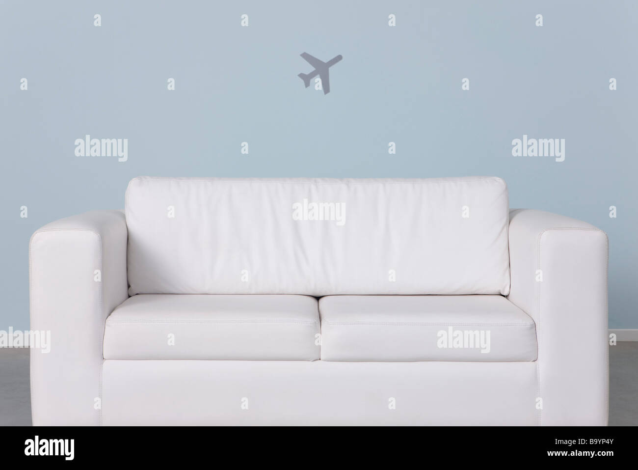 Sofa and airplane shape in background Stock Photo - Alamy