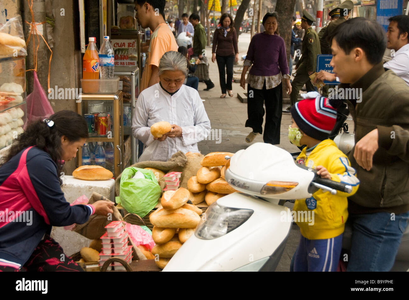 french bread seller on the streets of Hanoi Vietnam Stock Photo - Alamy