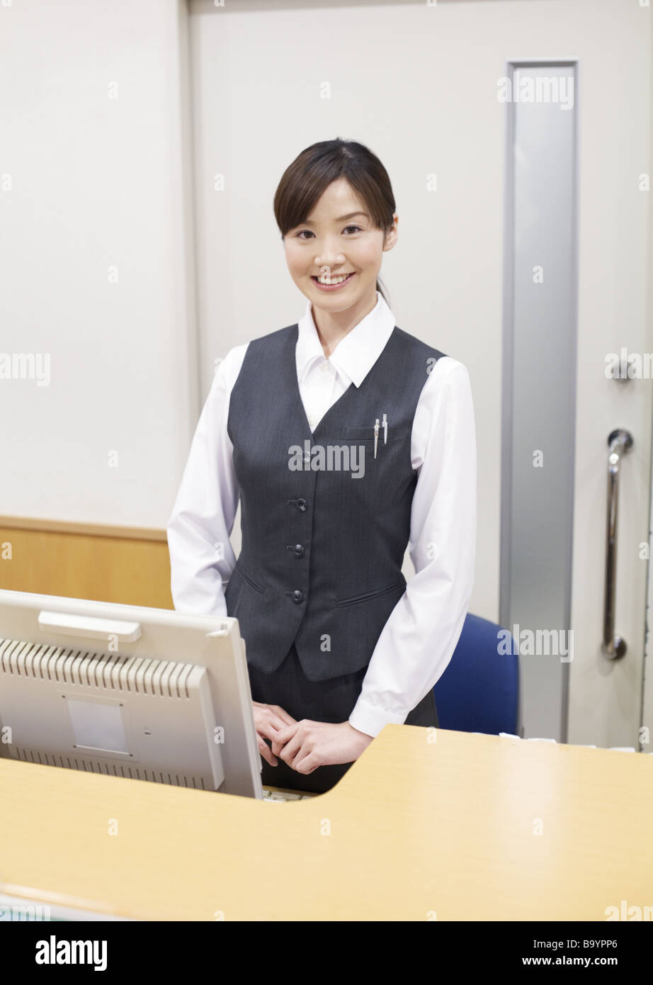 A smiling receptionist Stock Photo - Alamy