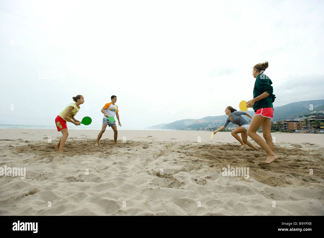 Teen friends playing paddleball on beach Stock Photo - Alamy