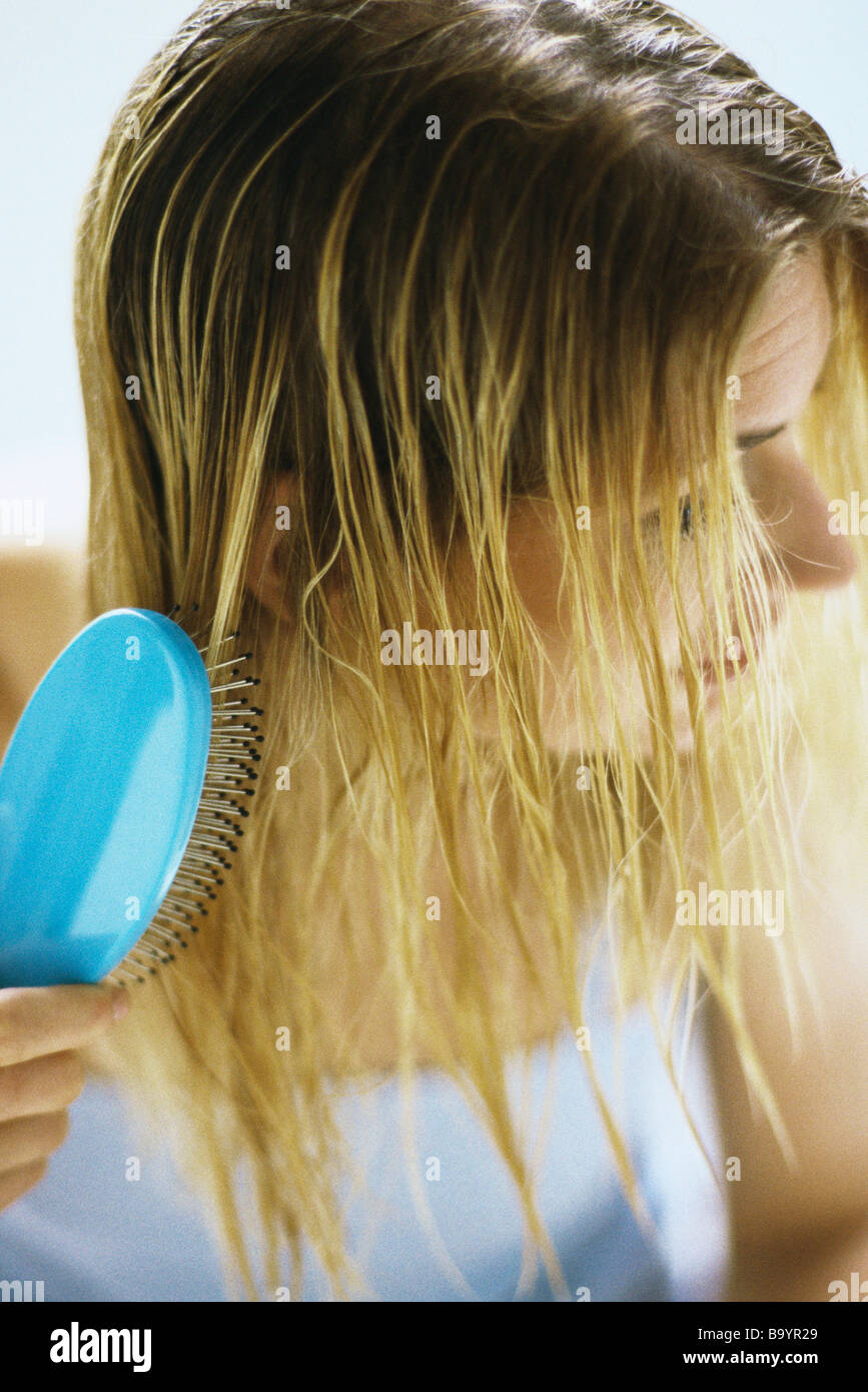 Woman brushing hair Stock Photo - Alamy
