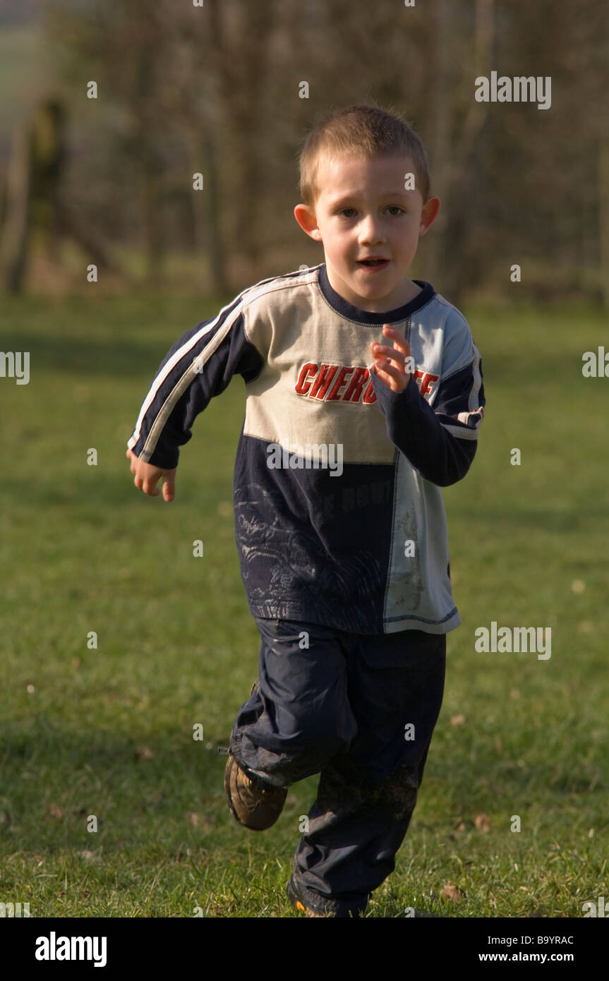 Boy running in garden England UK Europe Stock Photo - Alamy