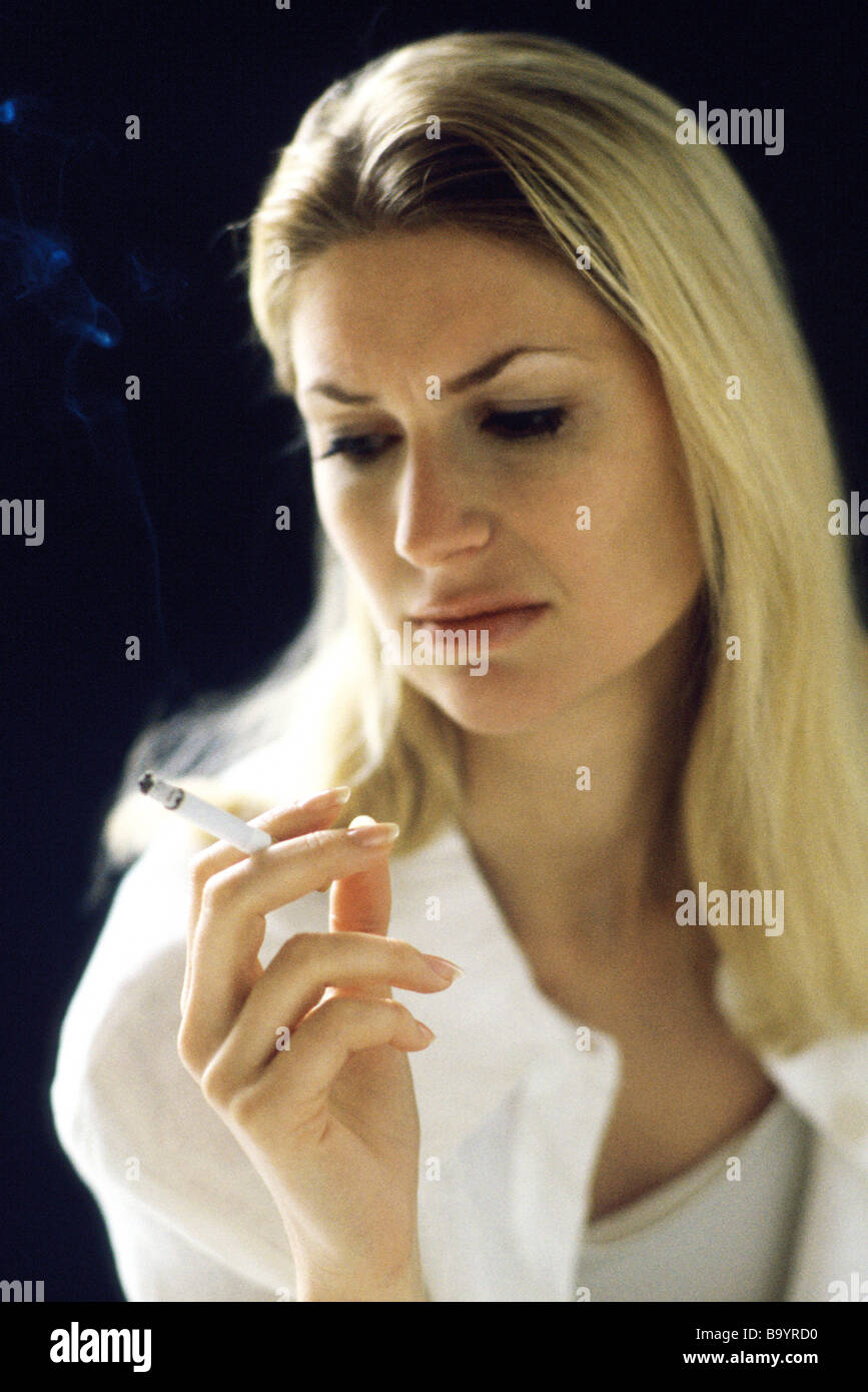 Woman Holding Cigarette Looking Down Stock Photo Alamy