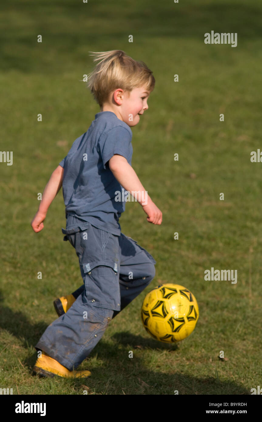 Children playing football in garden England UK Europe Stock Photo - Alamy