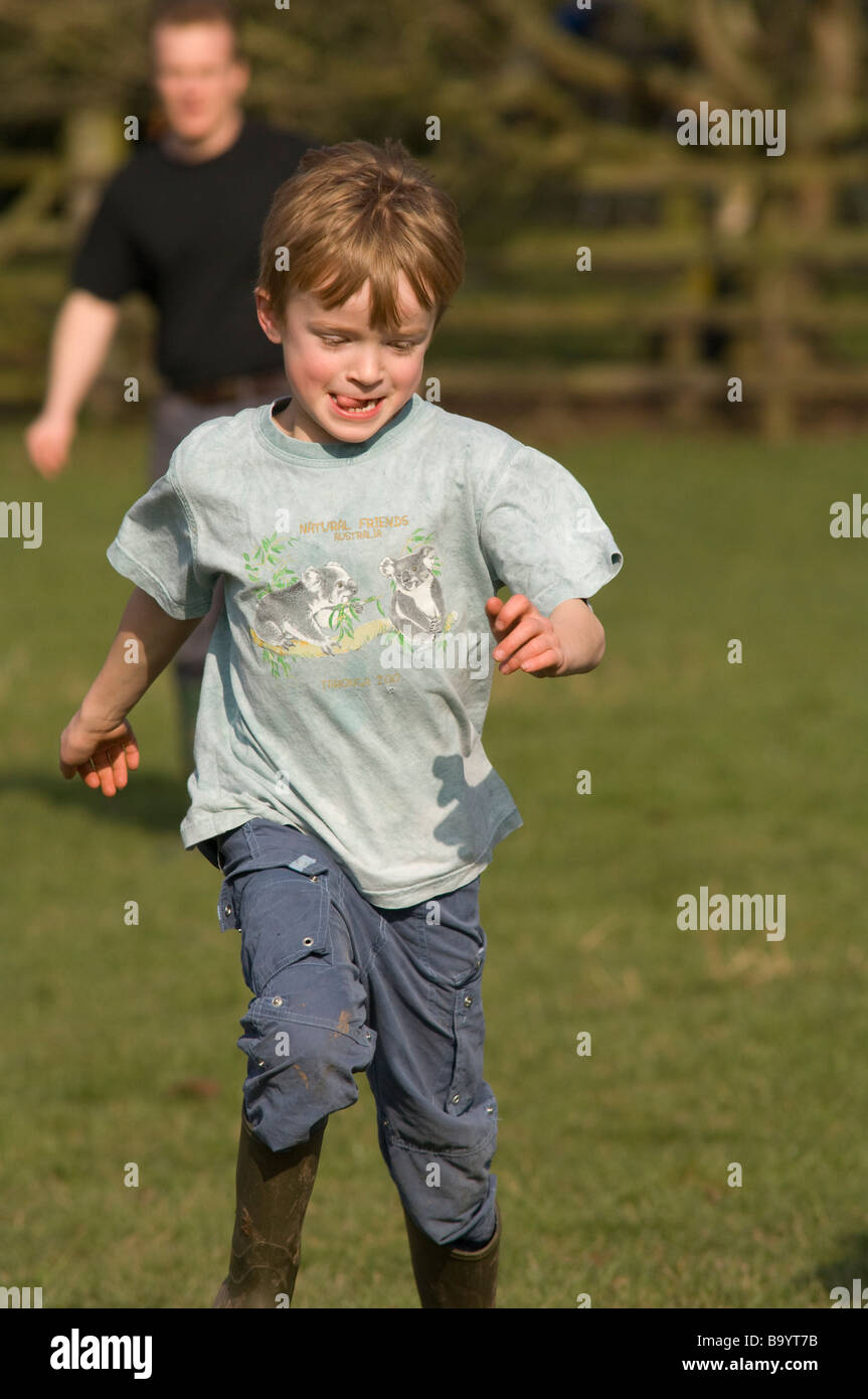 Boy running in garden England UK Europe Stock Photo - Alamy
