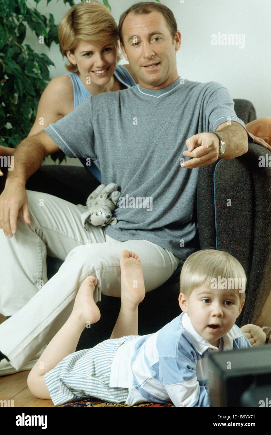 Family watching TV together, man pointing Stock Photo - Alamy