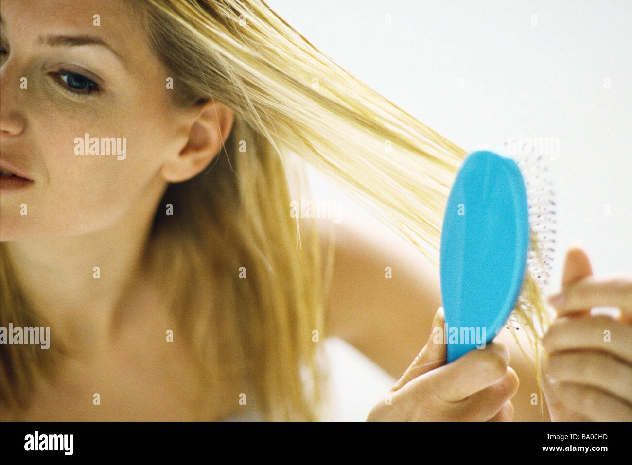 Woman brushing hair Stock Photo - Alamy