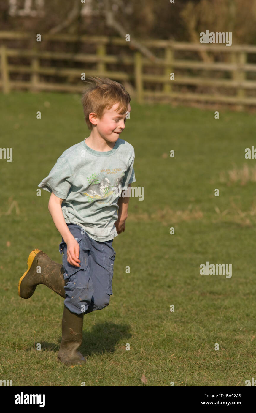 Boy running in garden England UK Europe Stock Photo - Alamy