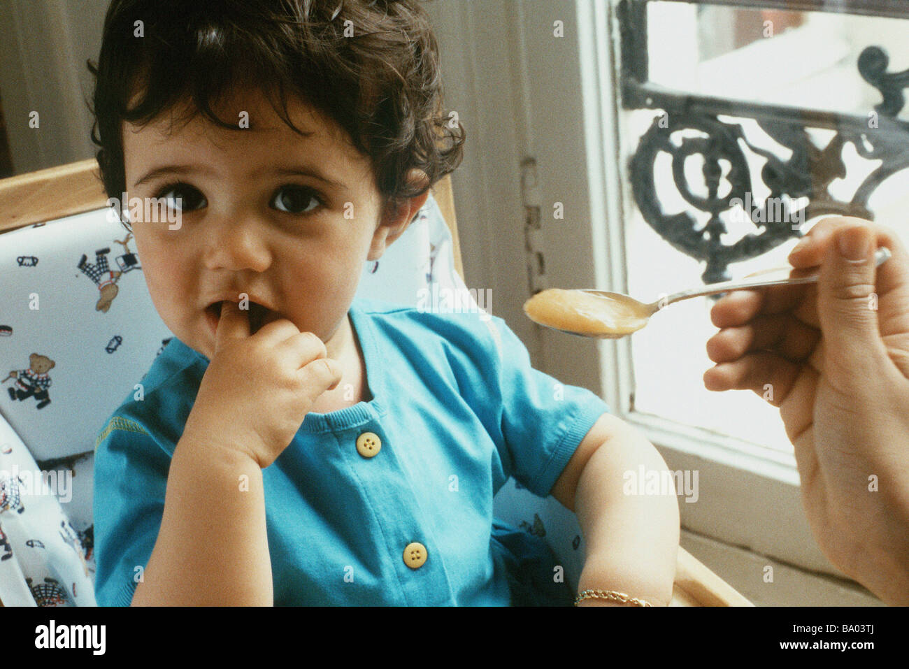 Little girl being spoon fed Stock Photo - Alamy