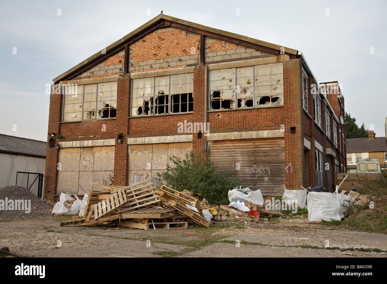 Broken glass building derelict dirty mess old pallets rubbish hi-res ...