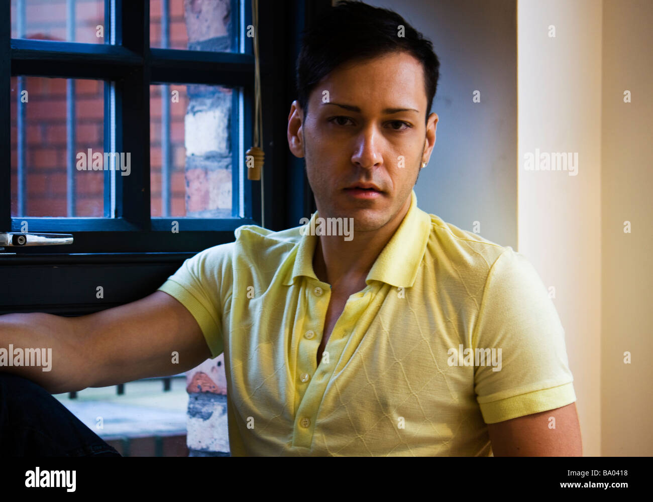 Man sitting in window Stock Photo - Alamy