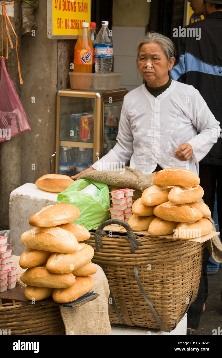 french bread seller on the streets of Hanoi Vietnam Stock Photo - Alamy