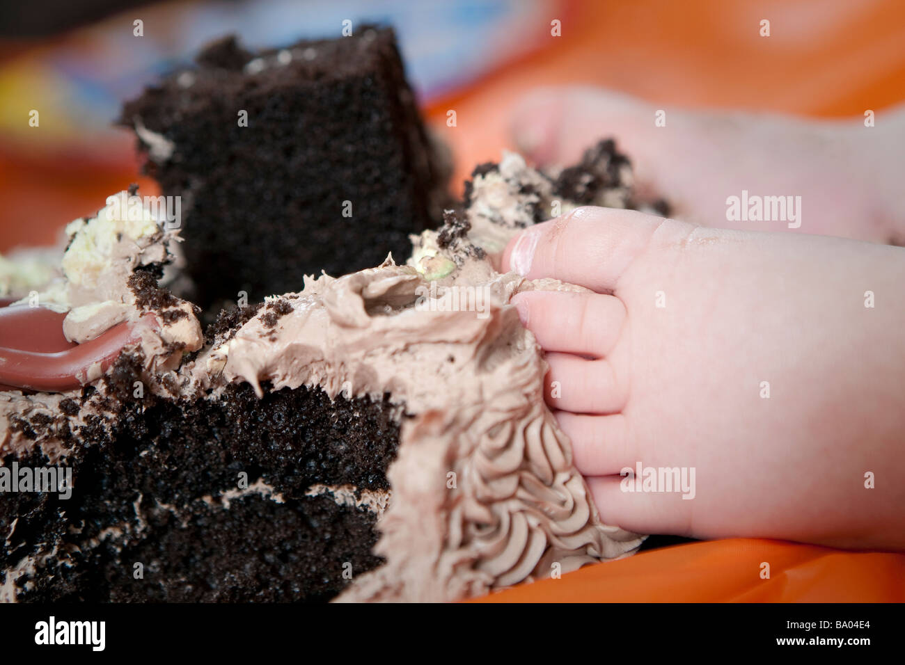 Baby feet in a birthday cake Stock Photo - Alamy
