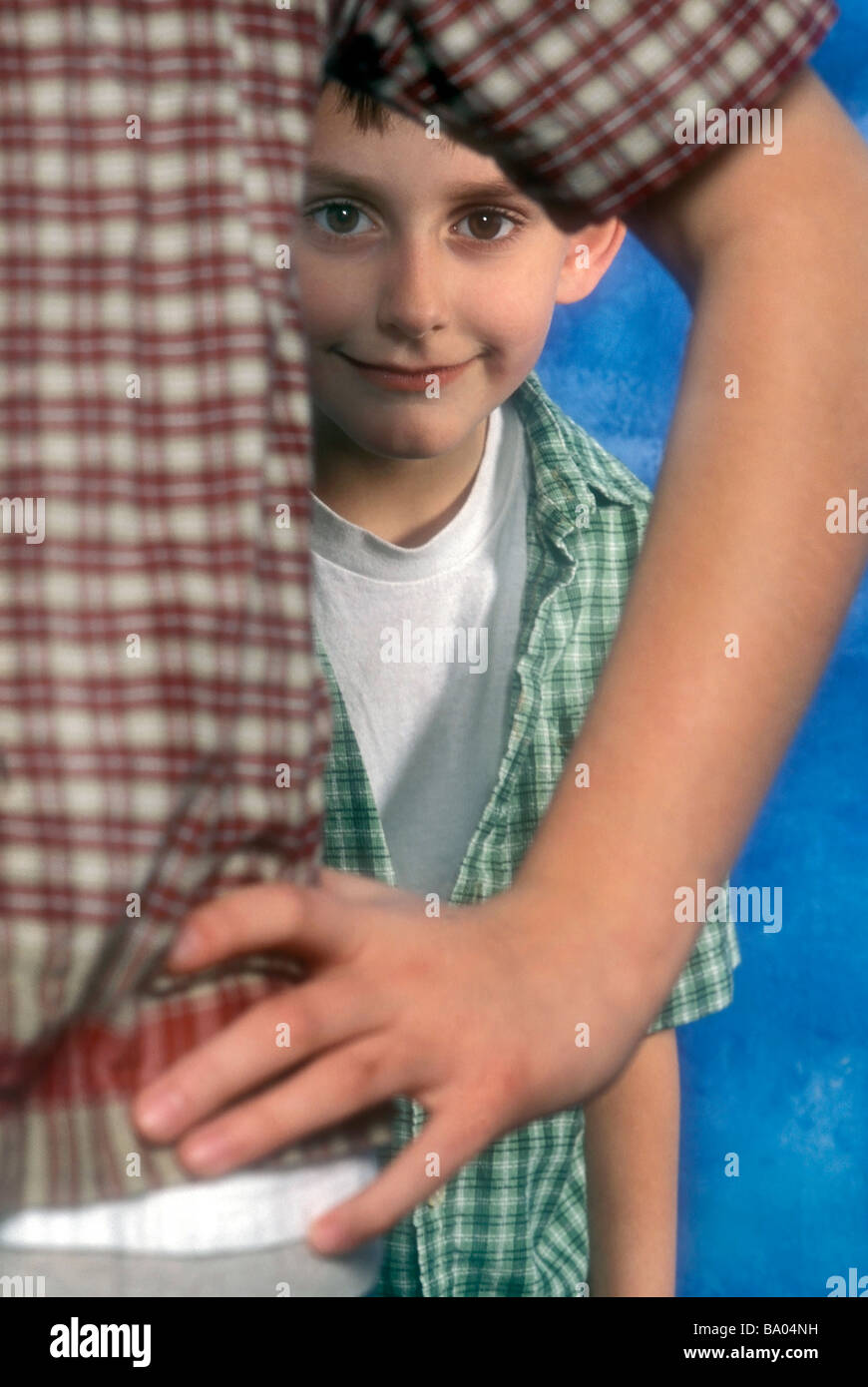 Hiding Behind Friends Arm Stock Photo - Alamy