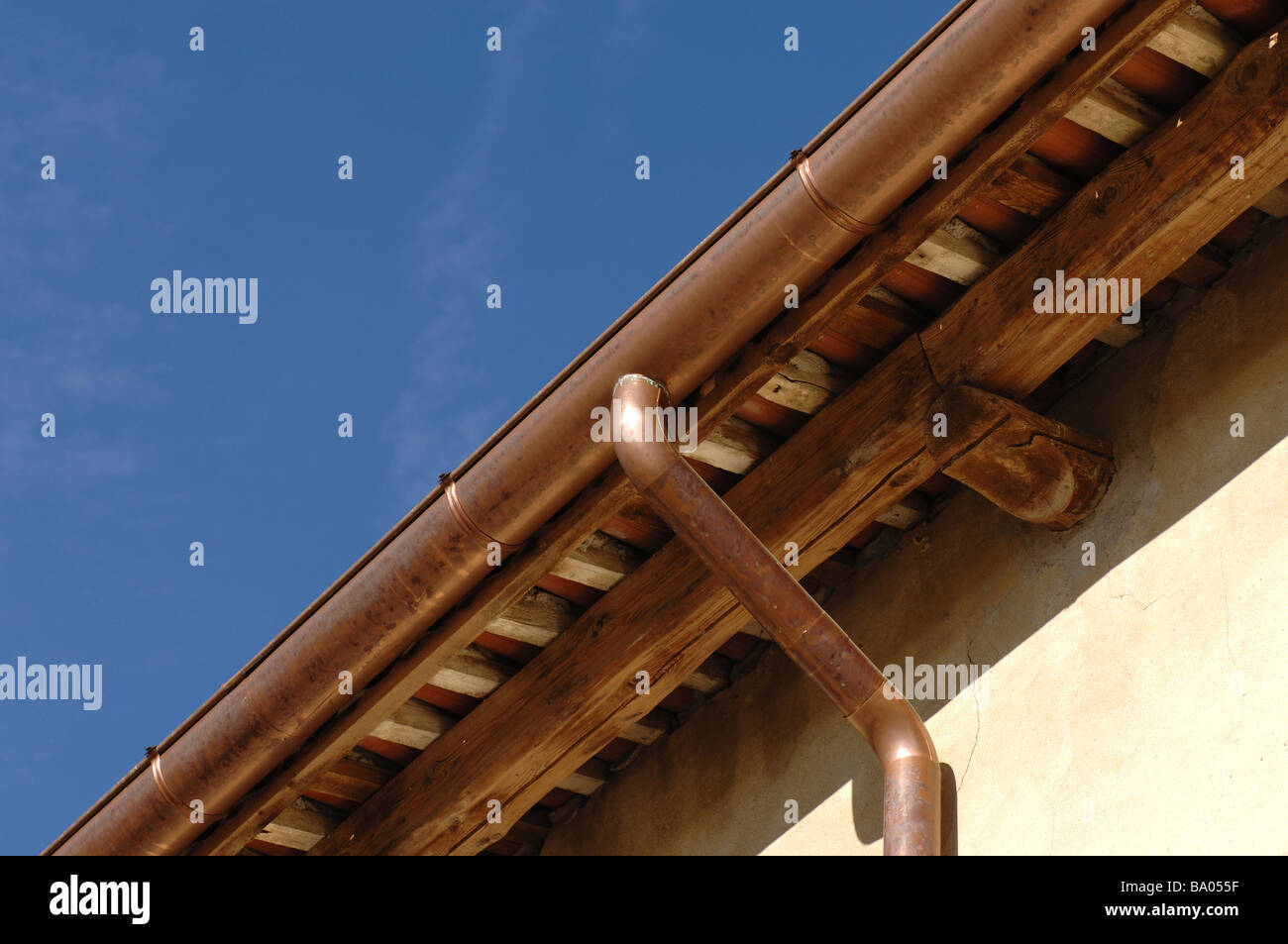 A copper gutter on an Italian farmhouse set against a blue sky Stock ...