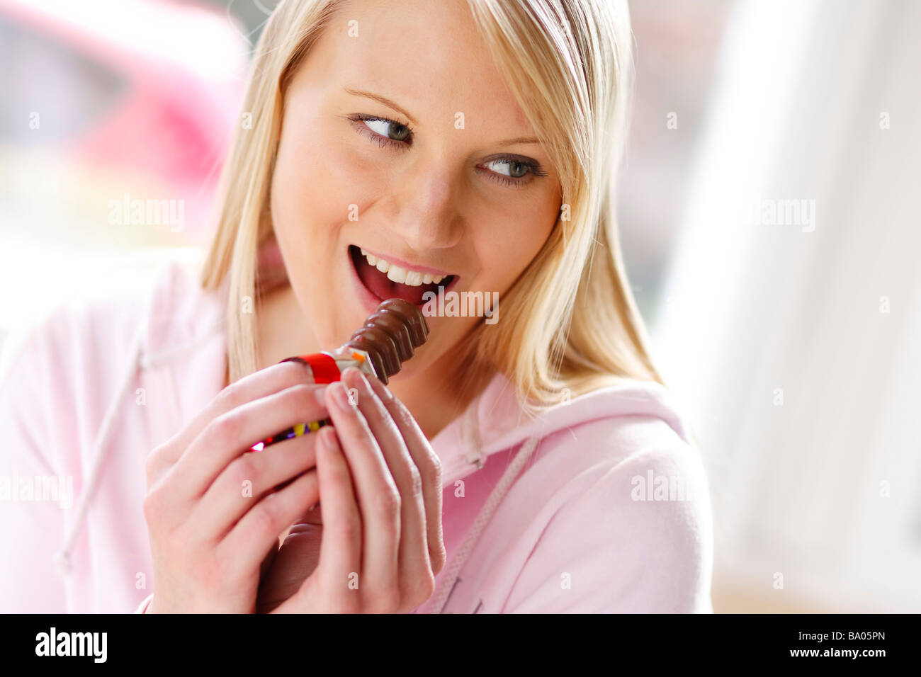 Girl with chocolate bar Stock Photo - Alamy