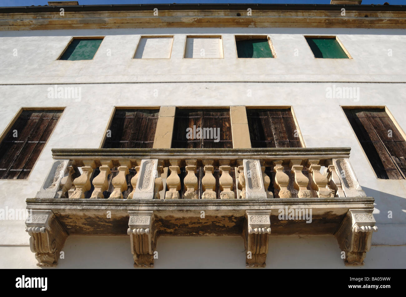 The aged wooden shuttered windows and balcony of a Venetian Palace ...