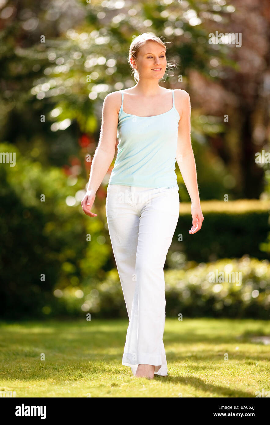 Woman walking outside Stock Photo - Alamy