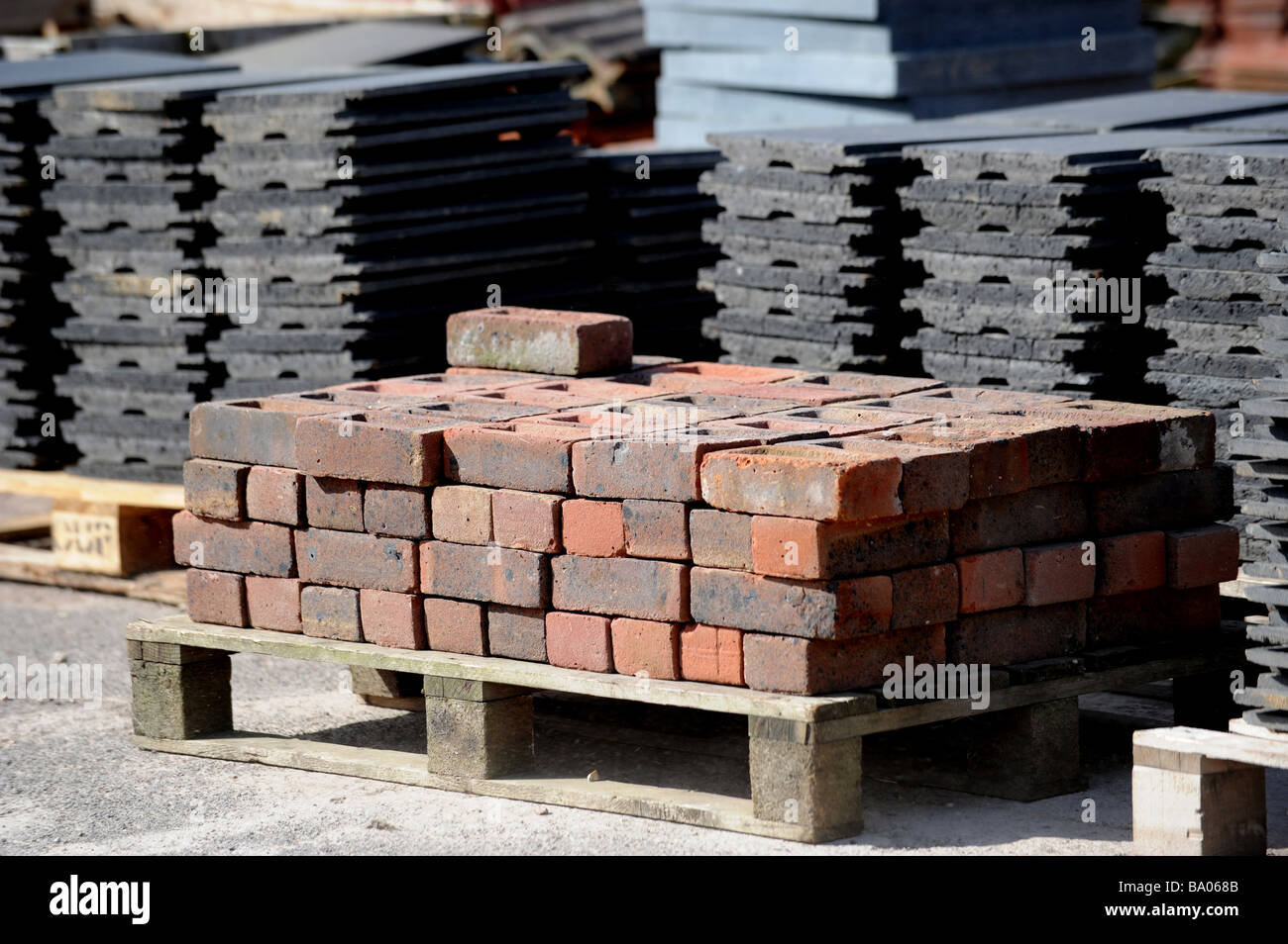 A pallet with a pile of reclaimed bricks are ready for resale in a ...
