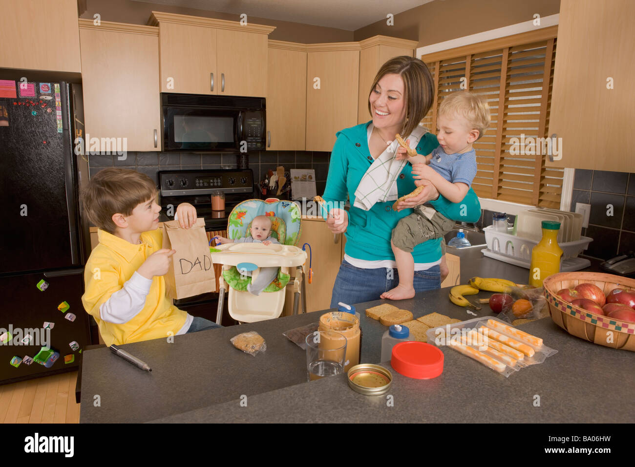 Stay at home mom with her kids Stock Photo - Alamy