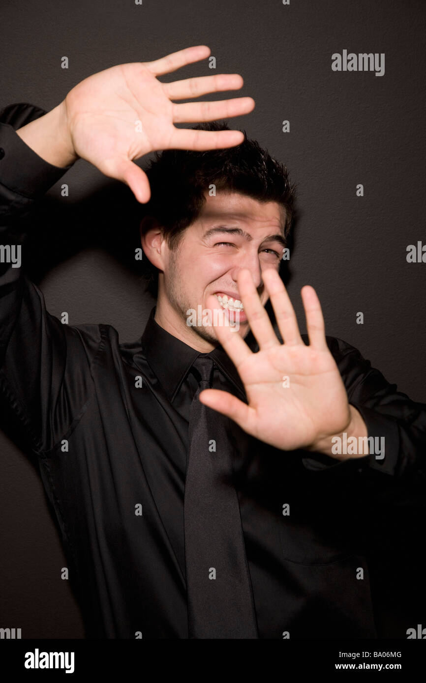 Man with hands blocking light Stock Photo - Alamy