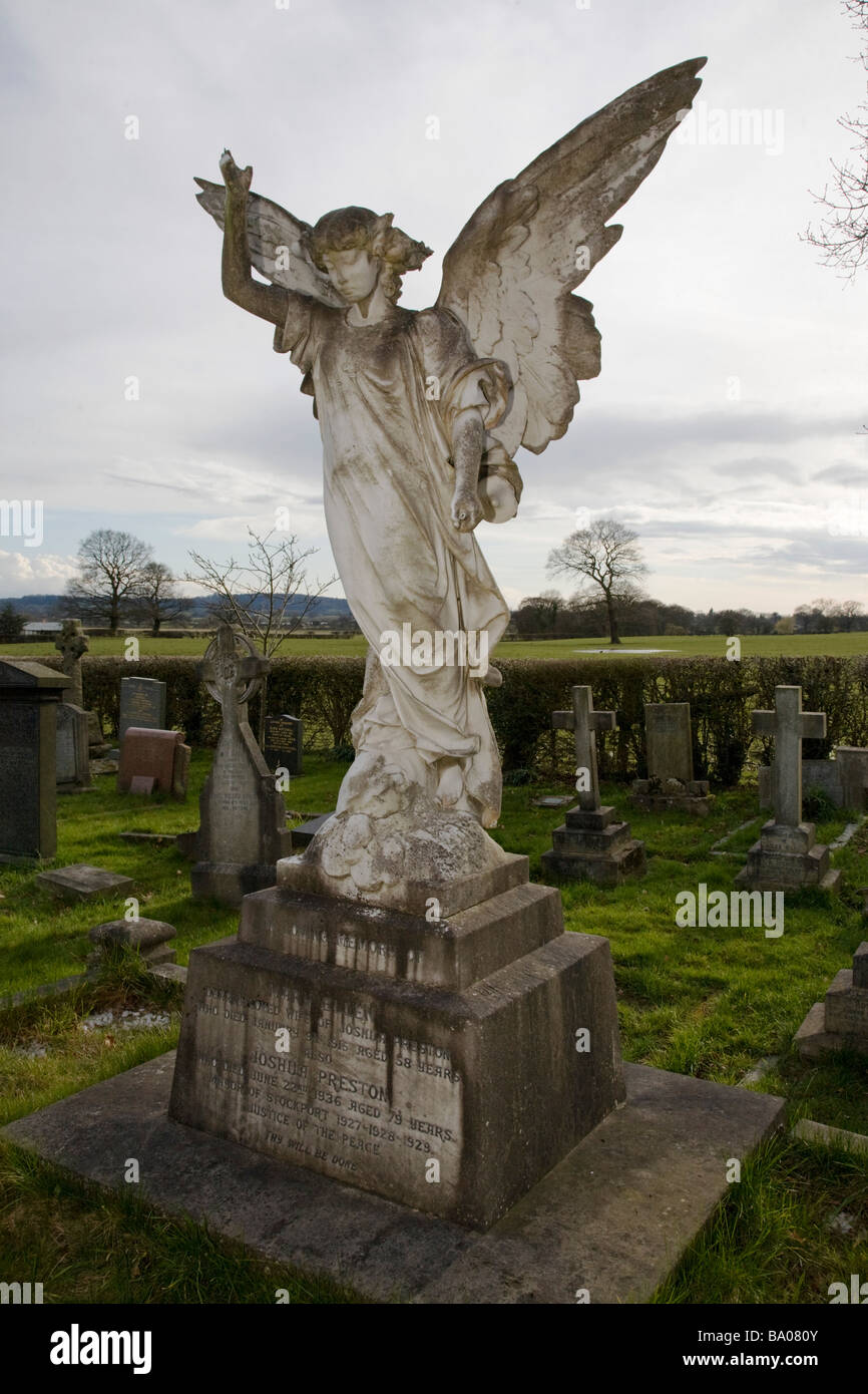 Statue of a stone angel in a graveyard. Christ Church, Woodford ...